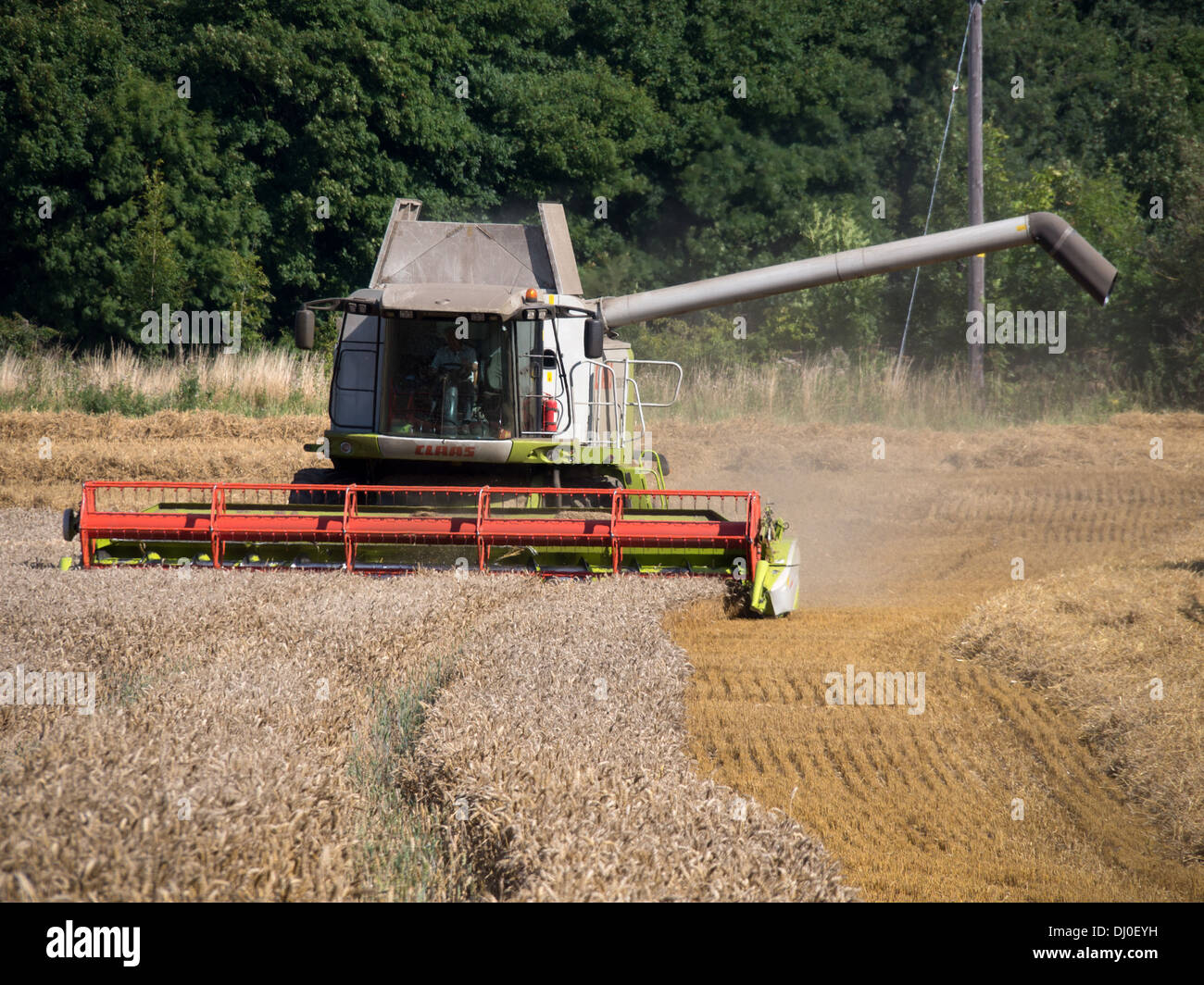 Combine harvester mowing field south yorkshire uk Stock Photo - Alamy