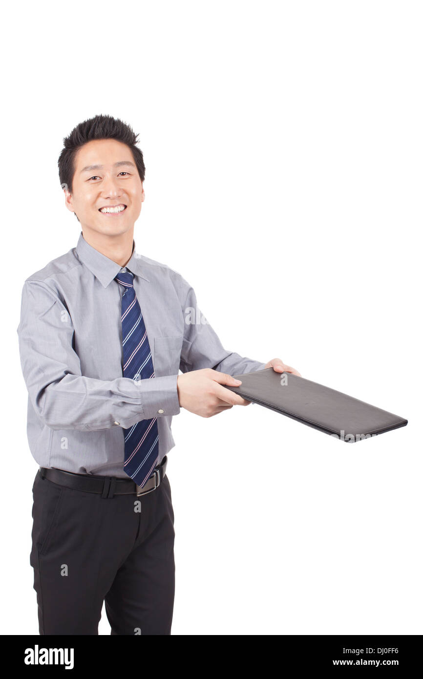 Businessman holding notebook posing in studio Stock Photo - Alamy