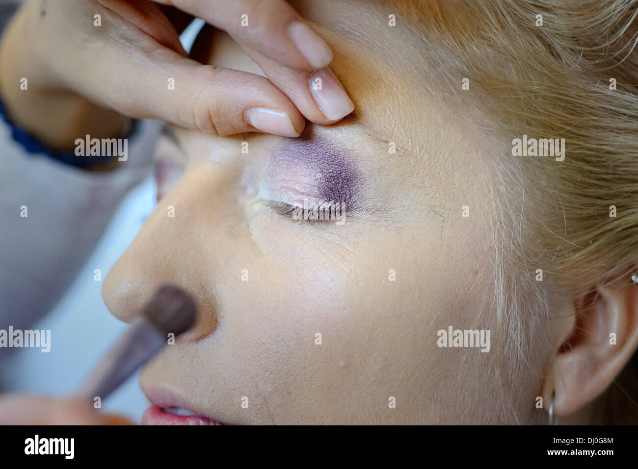 Putting eye shades on Stock Photo - Alamy