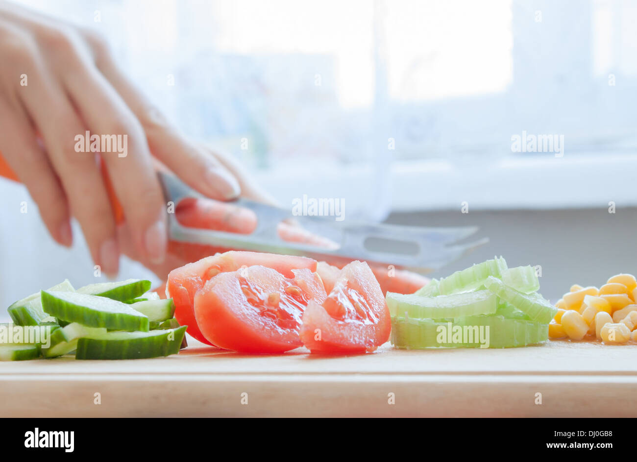 Hands holding knife chopping vegetables in the kitchen, ingredients for ...