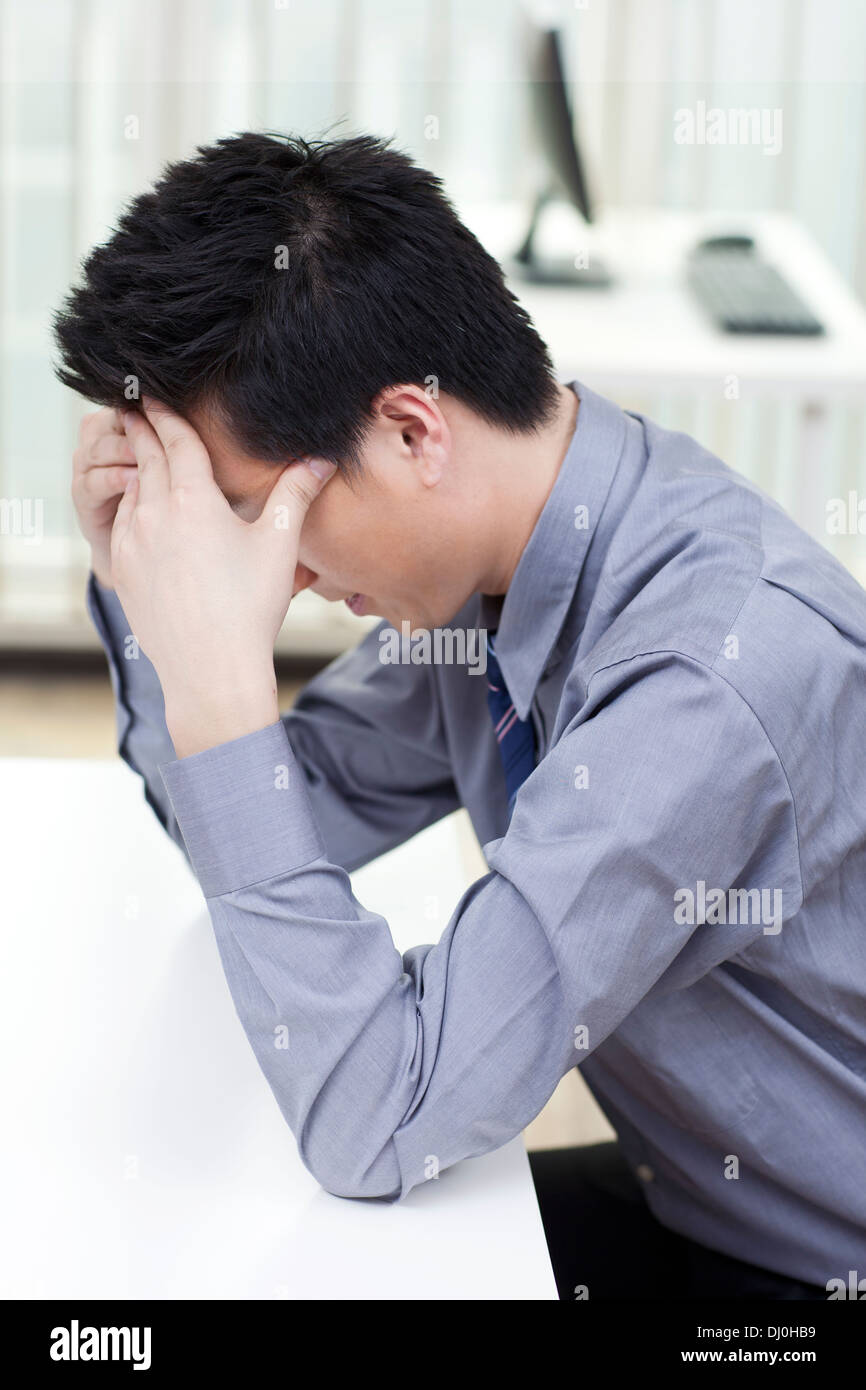 A man looks stressed as he works at his desk Stock Photo - Alamy