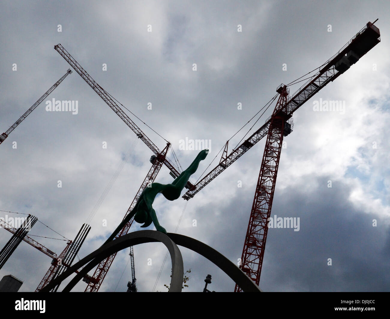 Acrobat sculpture "Up There" with tower cranes on First Street ...