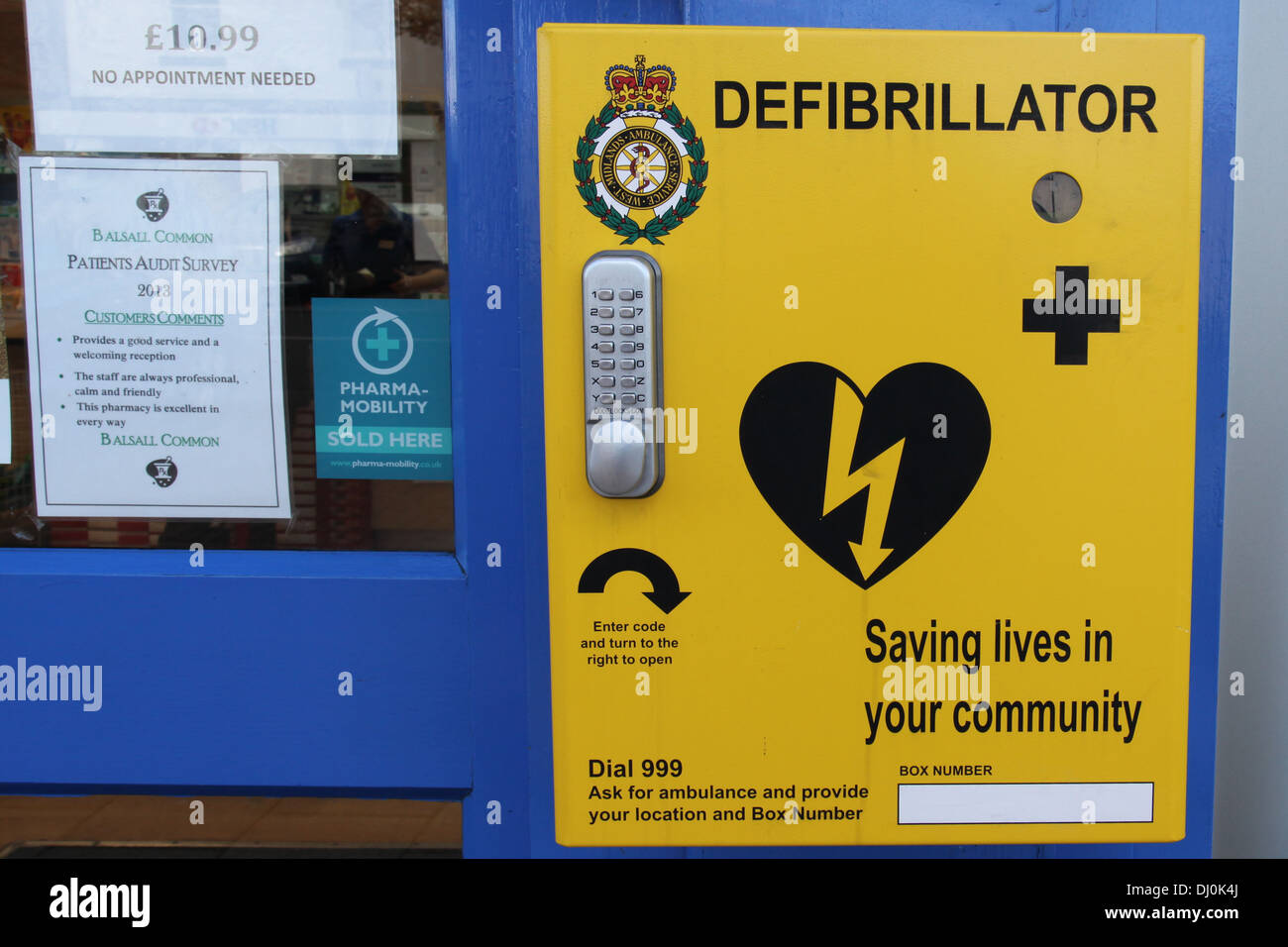 A bright yellow sign showing that a defibrillator machine is available ...