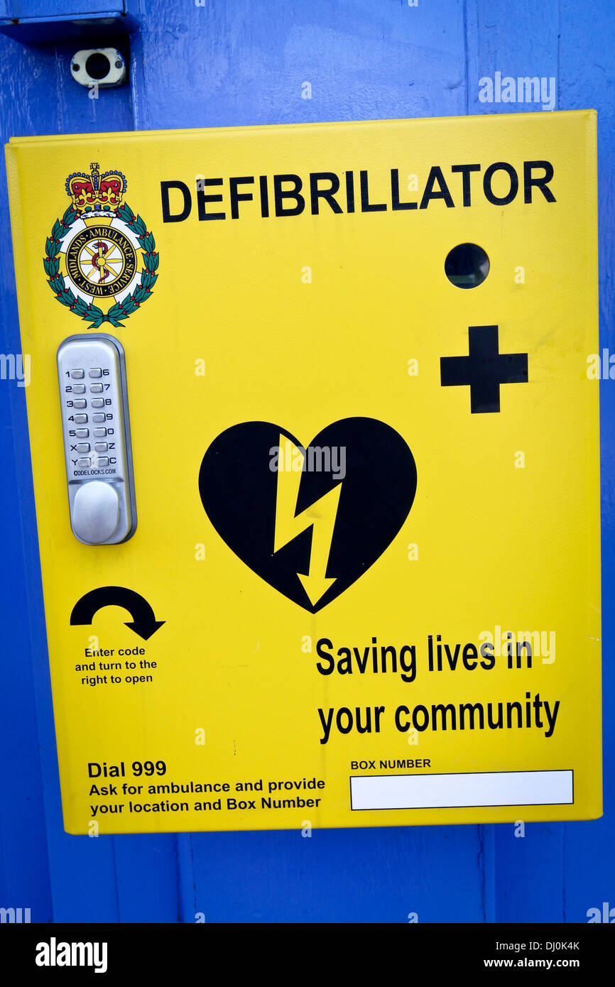 A bright yellow sign showing that a defibrillator machine is available ...