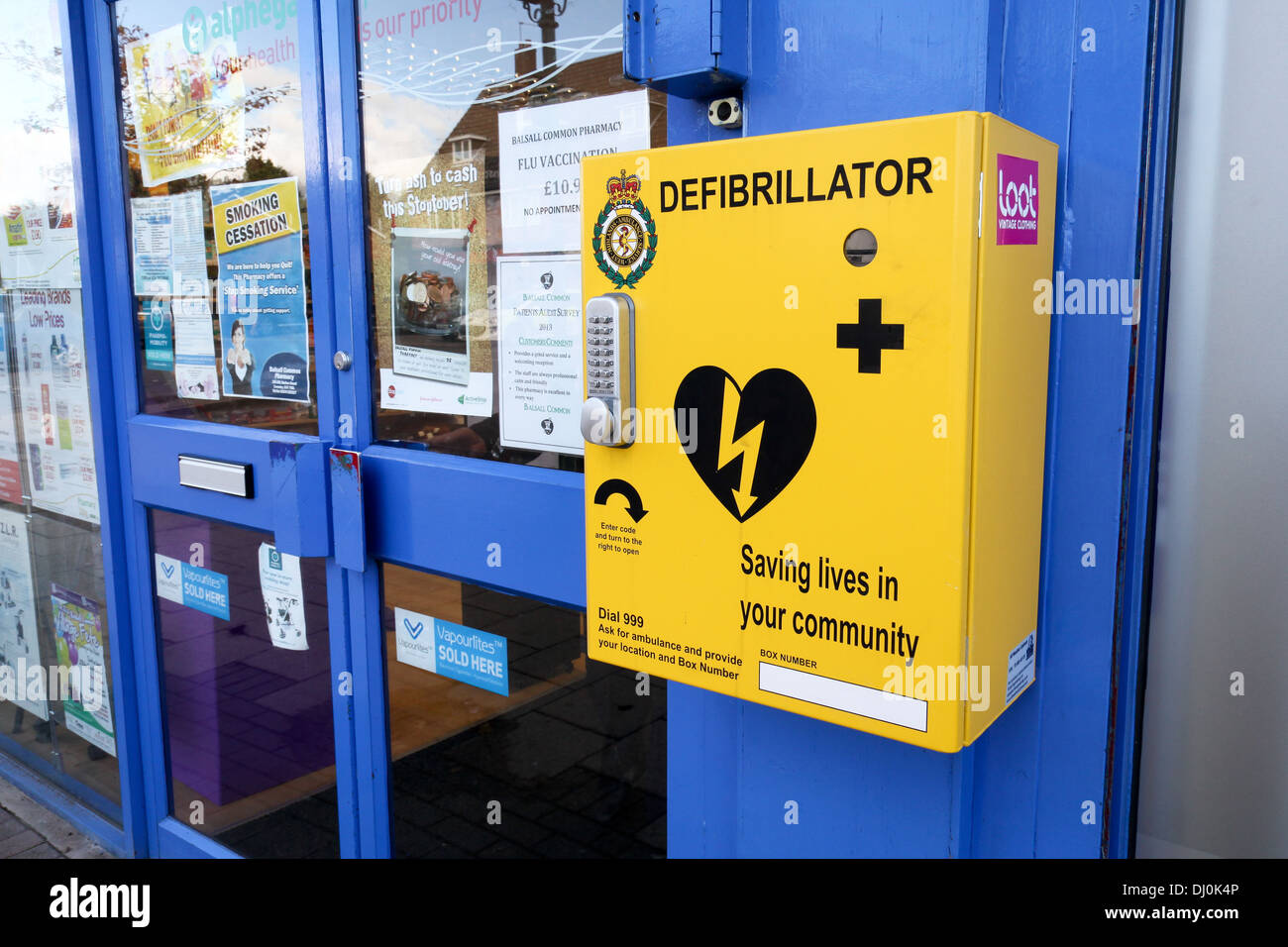 A bright yellow sign showing that a defibrillator machine is available ...