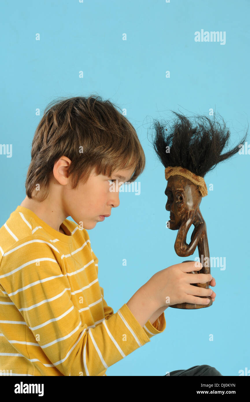 Boy in challenge with a statue Stock Photo - Alamy