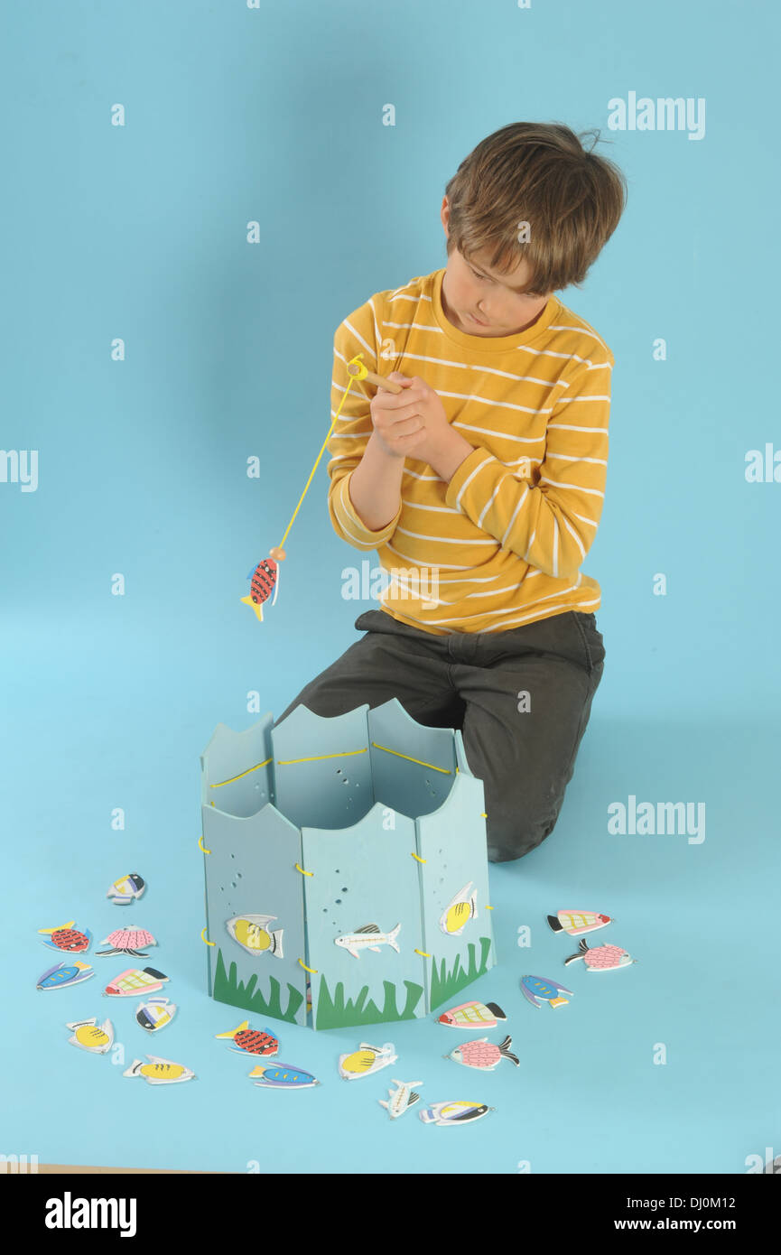 Boy playing with a fishing game Stock Photo - Alamy