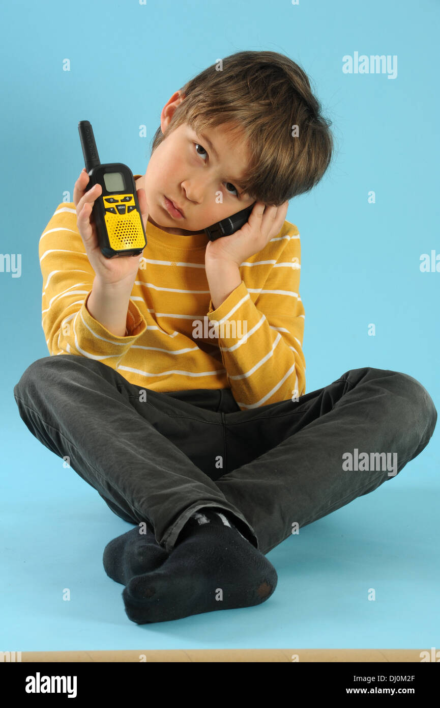 Boy talking with a walkie talkie Stock Photo - Alamy