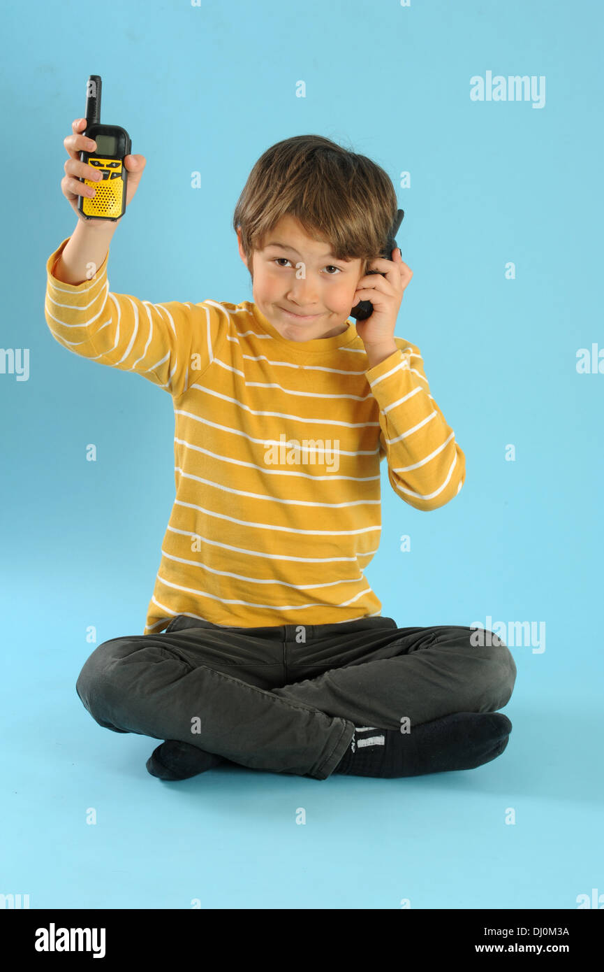 Boy talking with a walkie talkie Stock Photo - Alamy