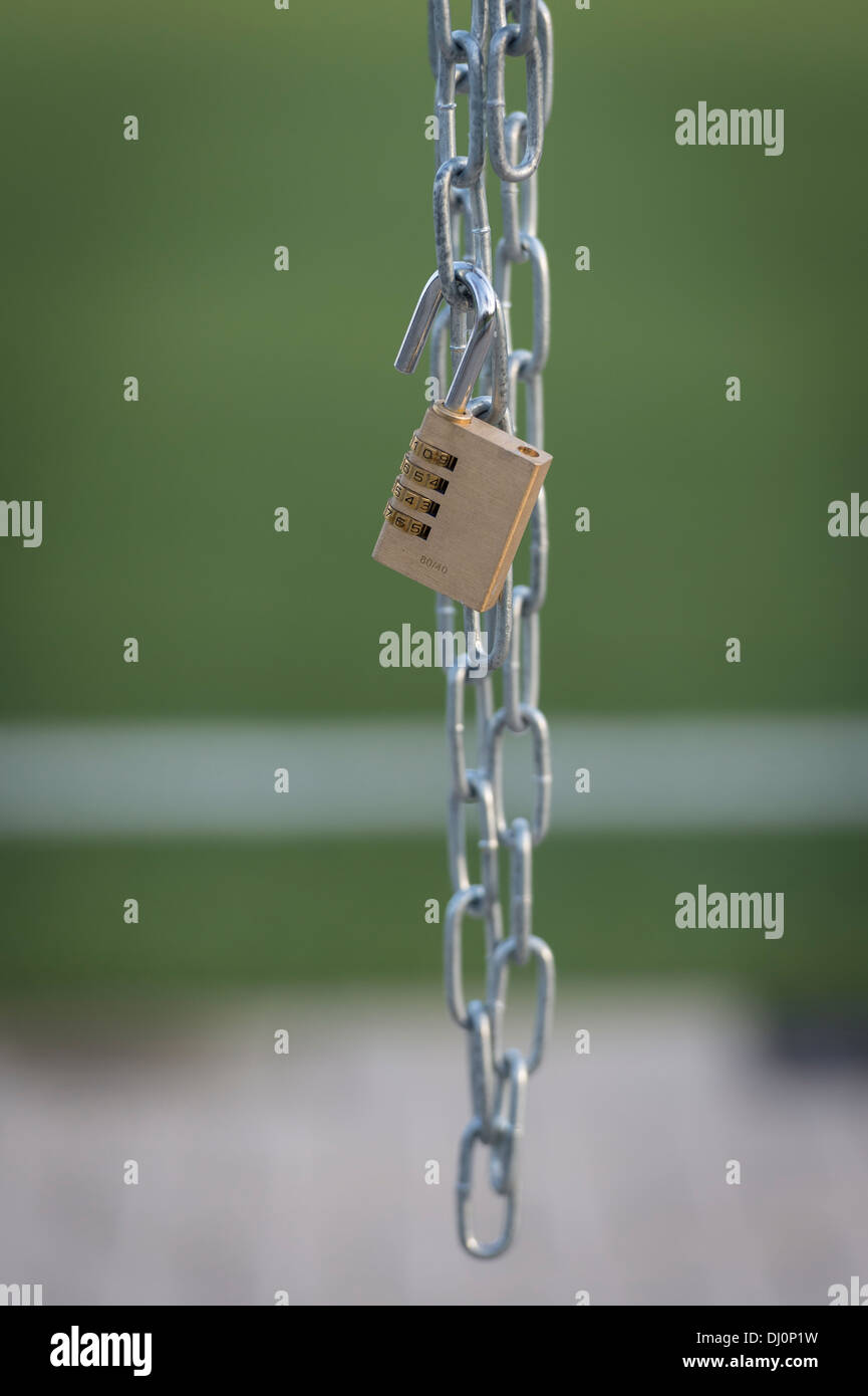 Open padlock hanging from chain Stock Photo - Alamy