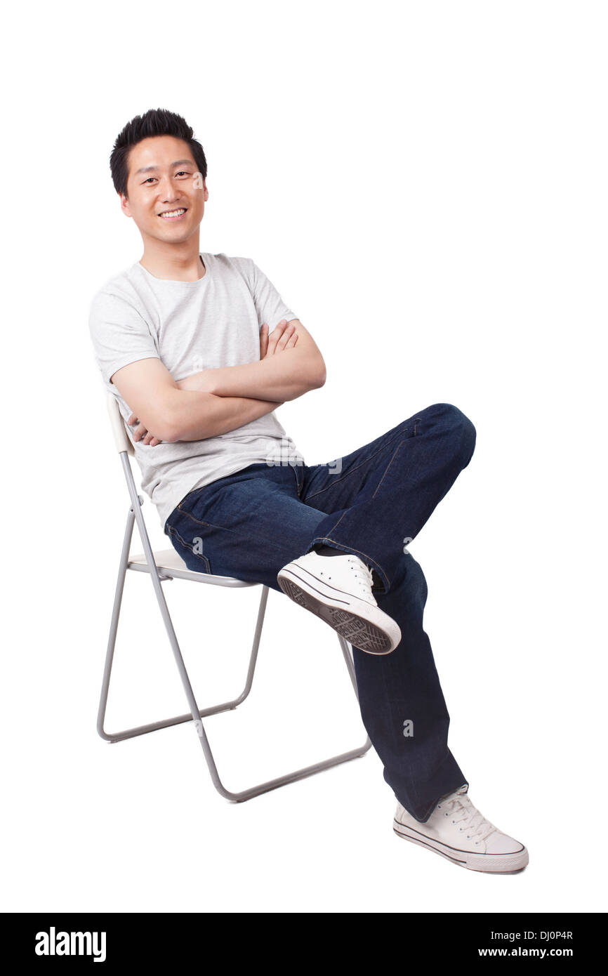 Successful young man sitting posture Stock Photo - Alamy