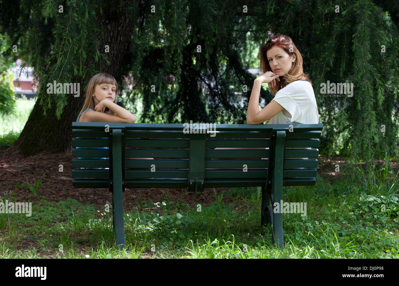 mother and daughter sitting on a bench Stock Photo - Alamy