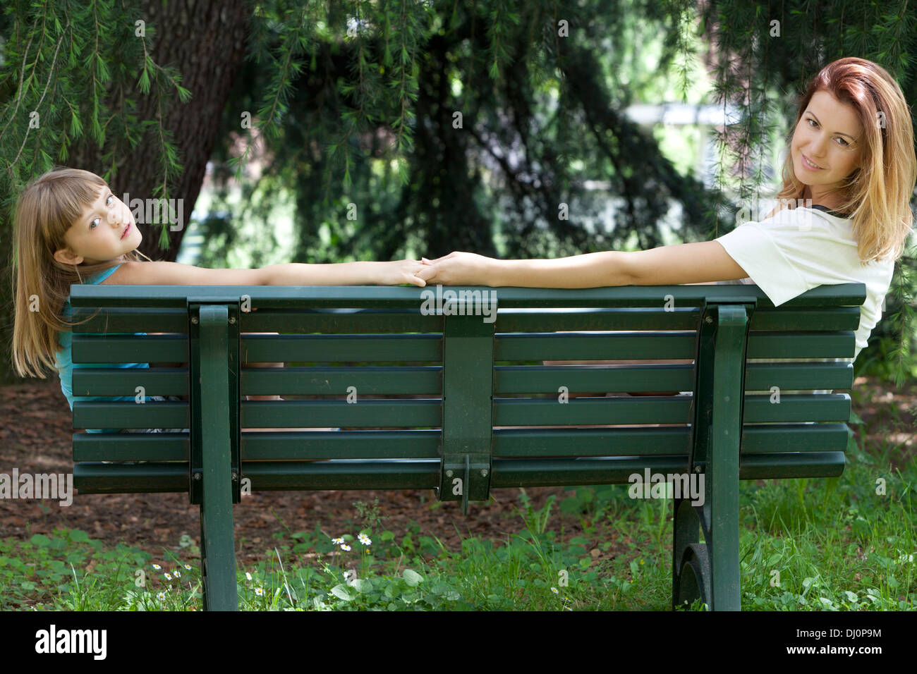 mother and daughter sitting on a bench Stock Photo - Alamy