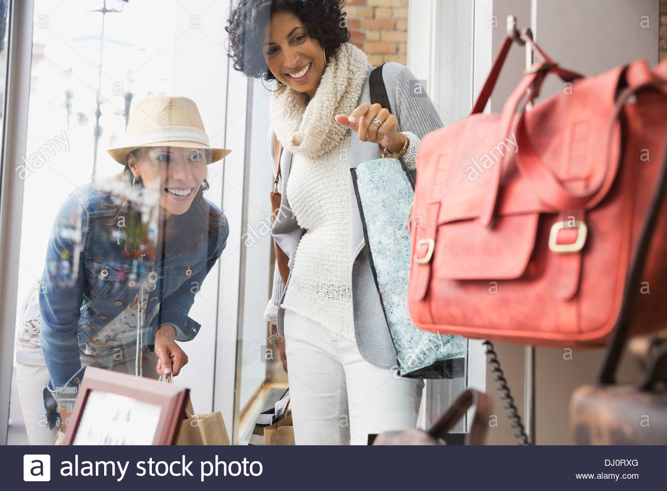 Female friends window shopping Stock Photo - Alamy