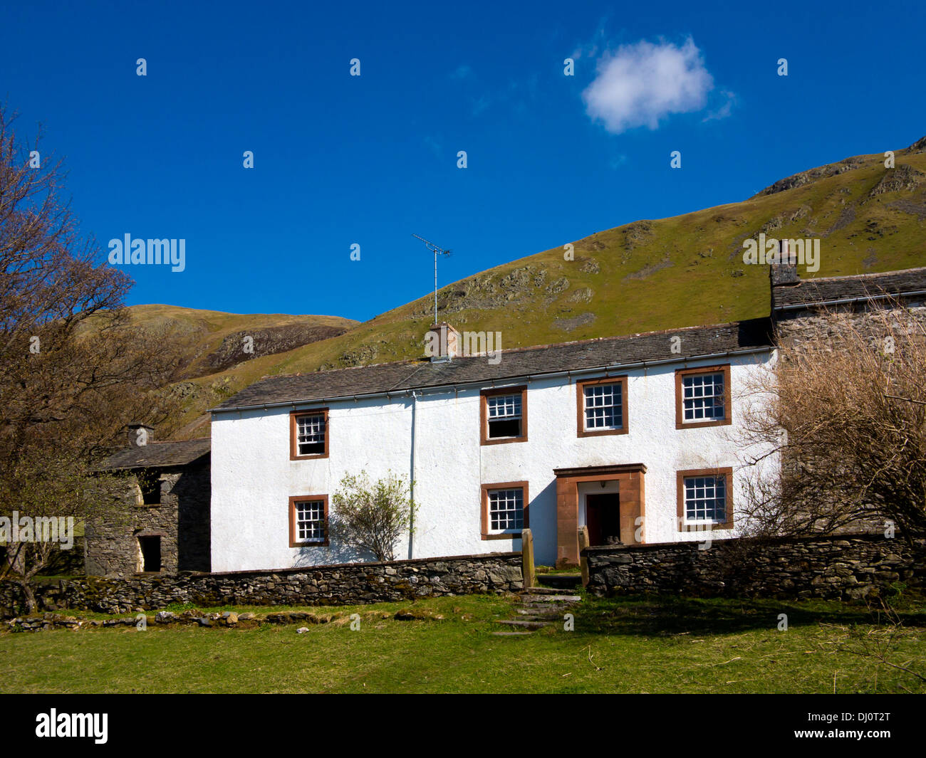 Traditional white painted farmhouse in Bonscale Pike near Ullswater in ...