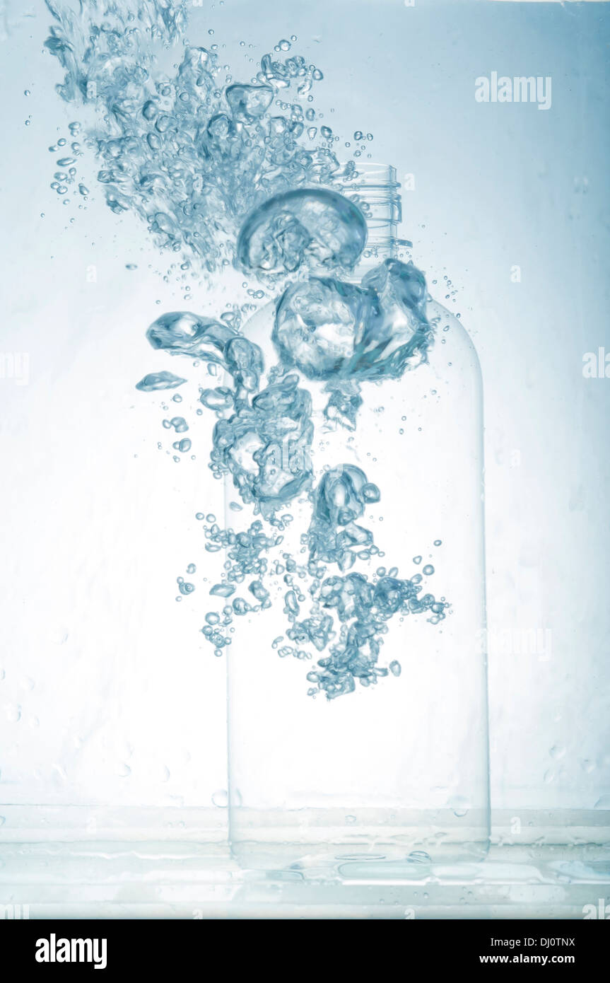 bottle falling and sinking in blue water Stock Photo - Alamy