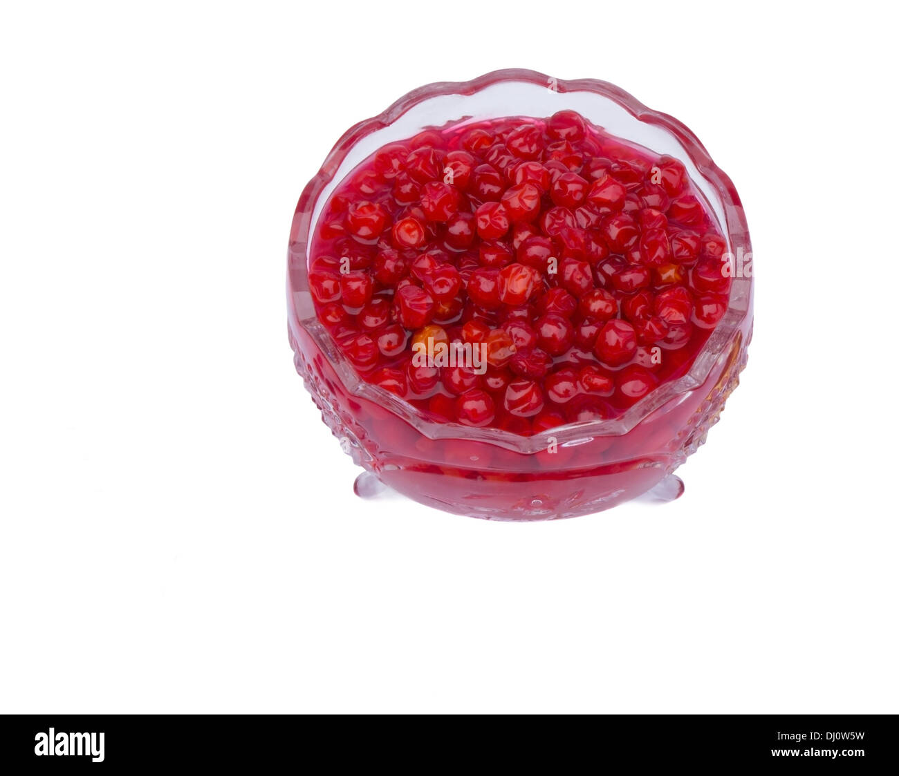 Bright red berries in a crystal vase filled with sugar syrup. Presented ...