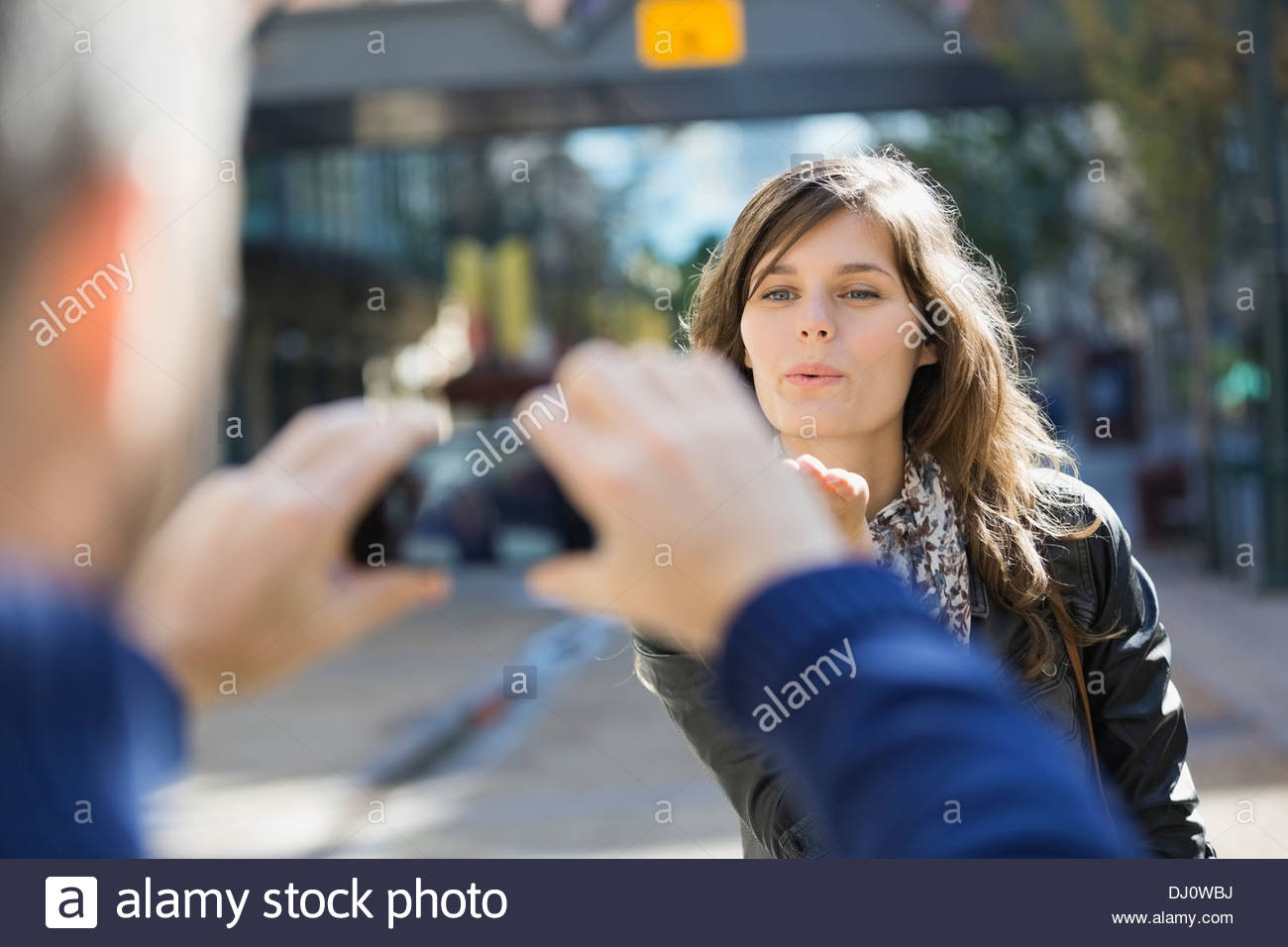 Man photographing woman blowing kiss Stock Photo - Alamy