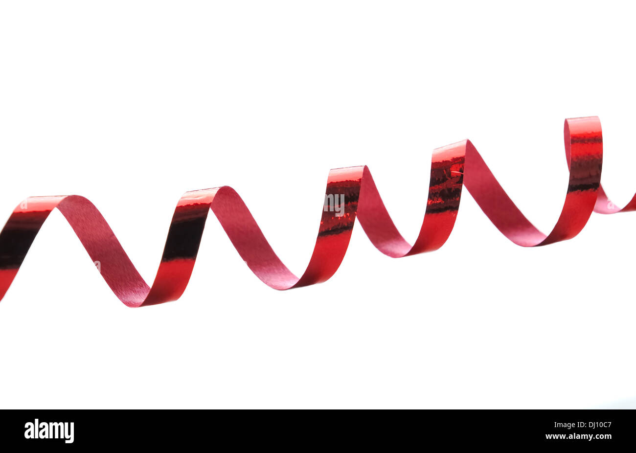 piece of red curling ribbon forming a boucle on white background Stock ...