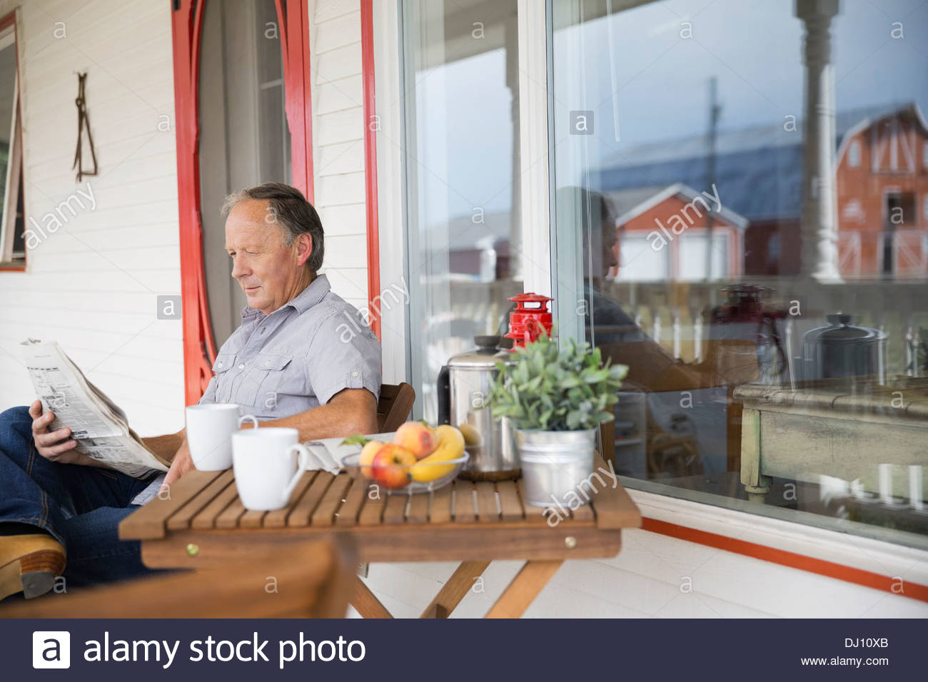 Man reading newspaper on porch hi-res stock photography and images - Alamy