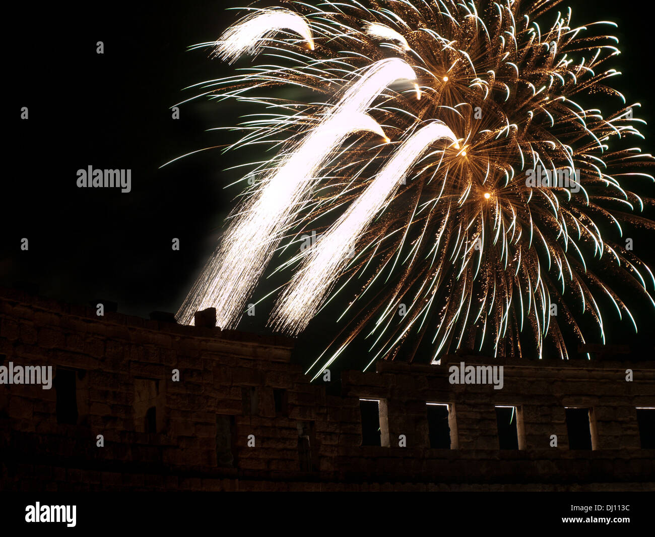 fireworks in summer night over arena Stock Photo - Alamy
