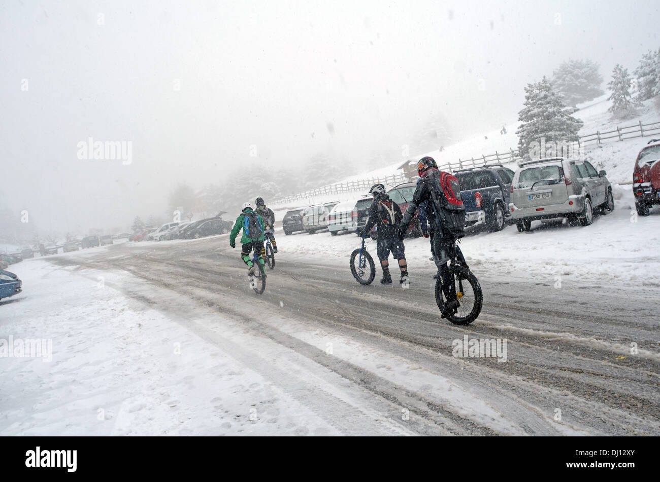 One-wheeled snow bikers in Peñalara natural park, Madrid Stock Photo ...