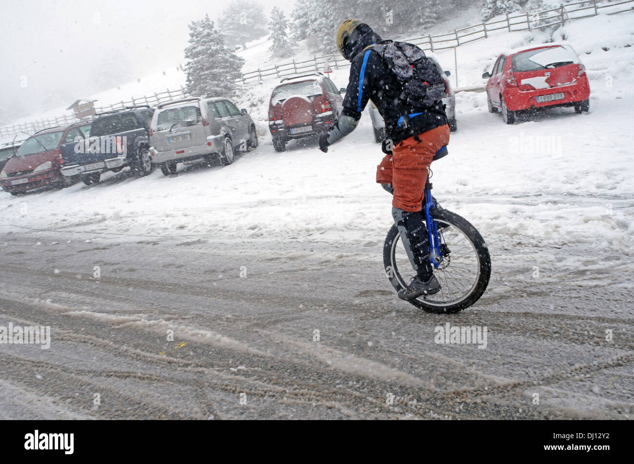 One-wheeled snow bikers in Peñalara natural park, Madrid Stock Photo ...