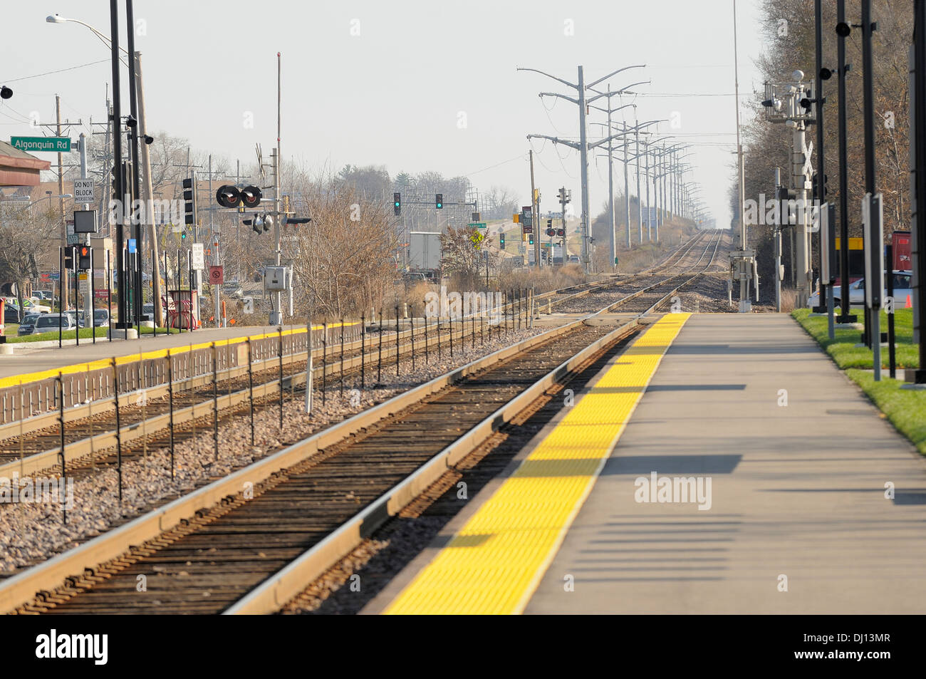 Suburban Train station platform and tracks Stock Photo - Alamy