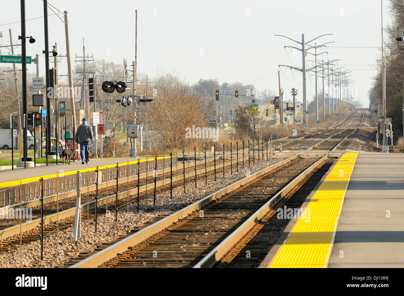 Suburban Train station platform and tracks Stock Photo - Alamy
