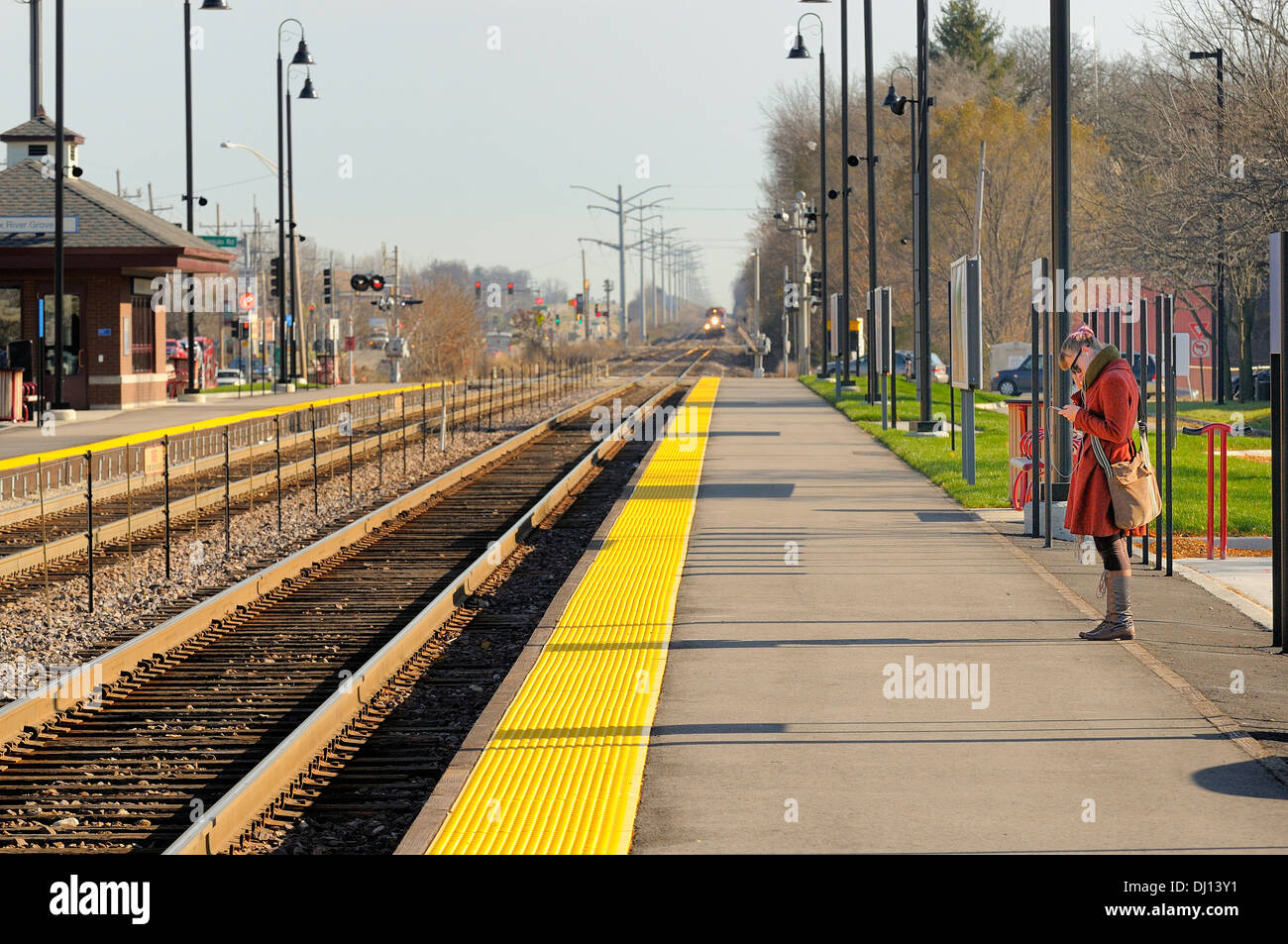 Suburban Train station platform and tracks Stock Photo - Alamy