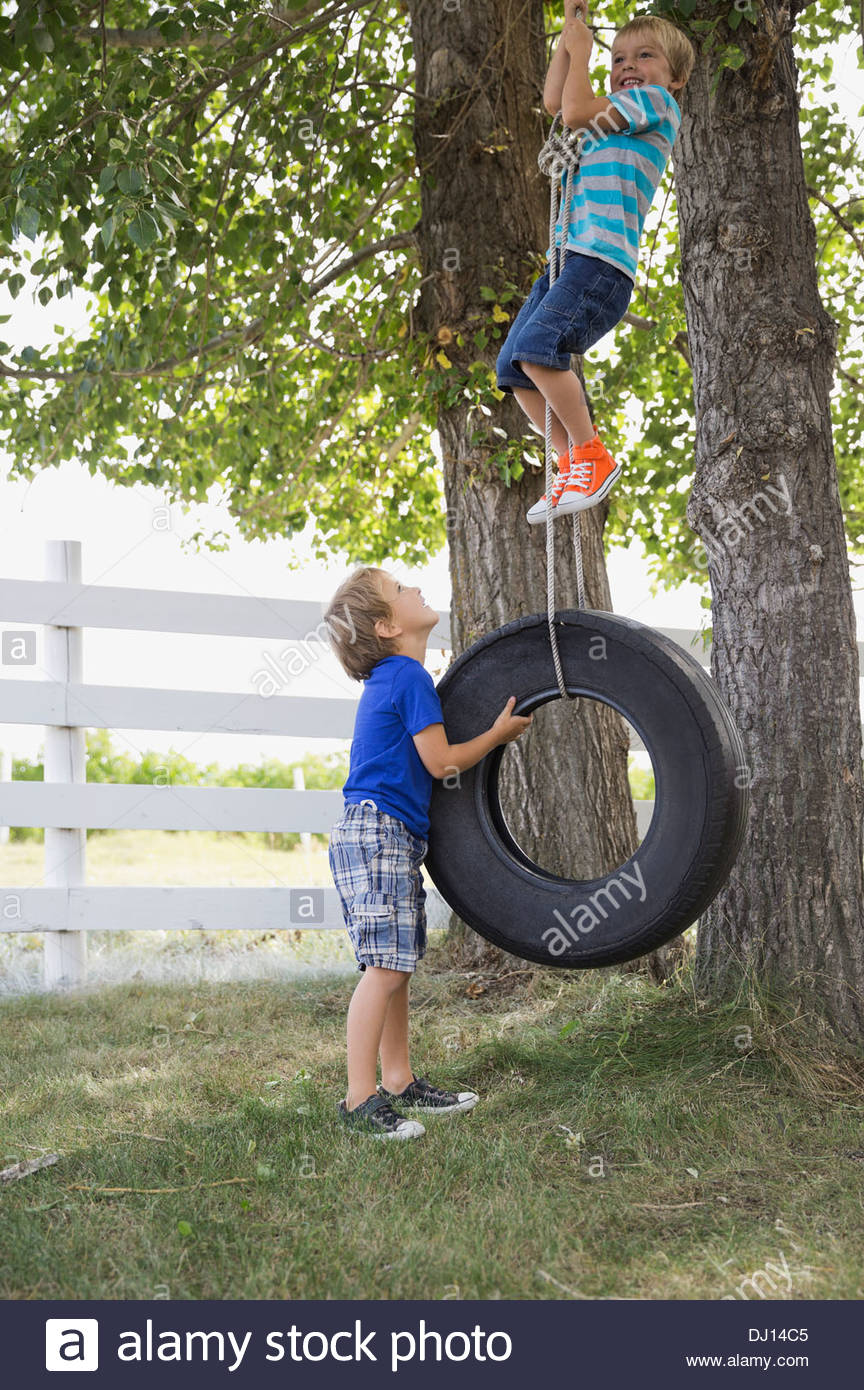 Boys playing swing hi-res stock photography and images - Alamy