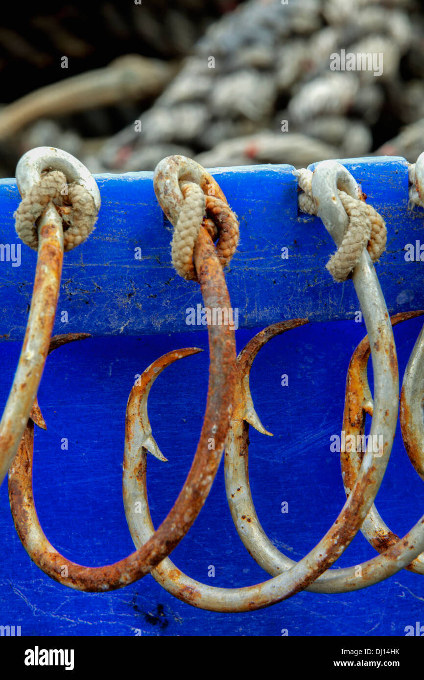 Rusted Hooks Tied Onto A Blue Edge Stock Photo - Alamy