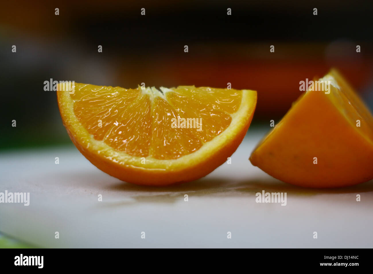 A side and front view of two large orange segments. Main focal point on ...