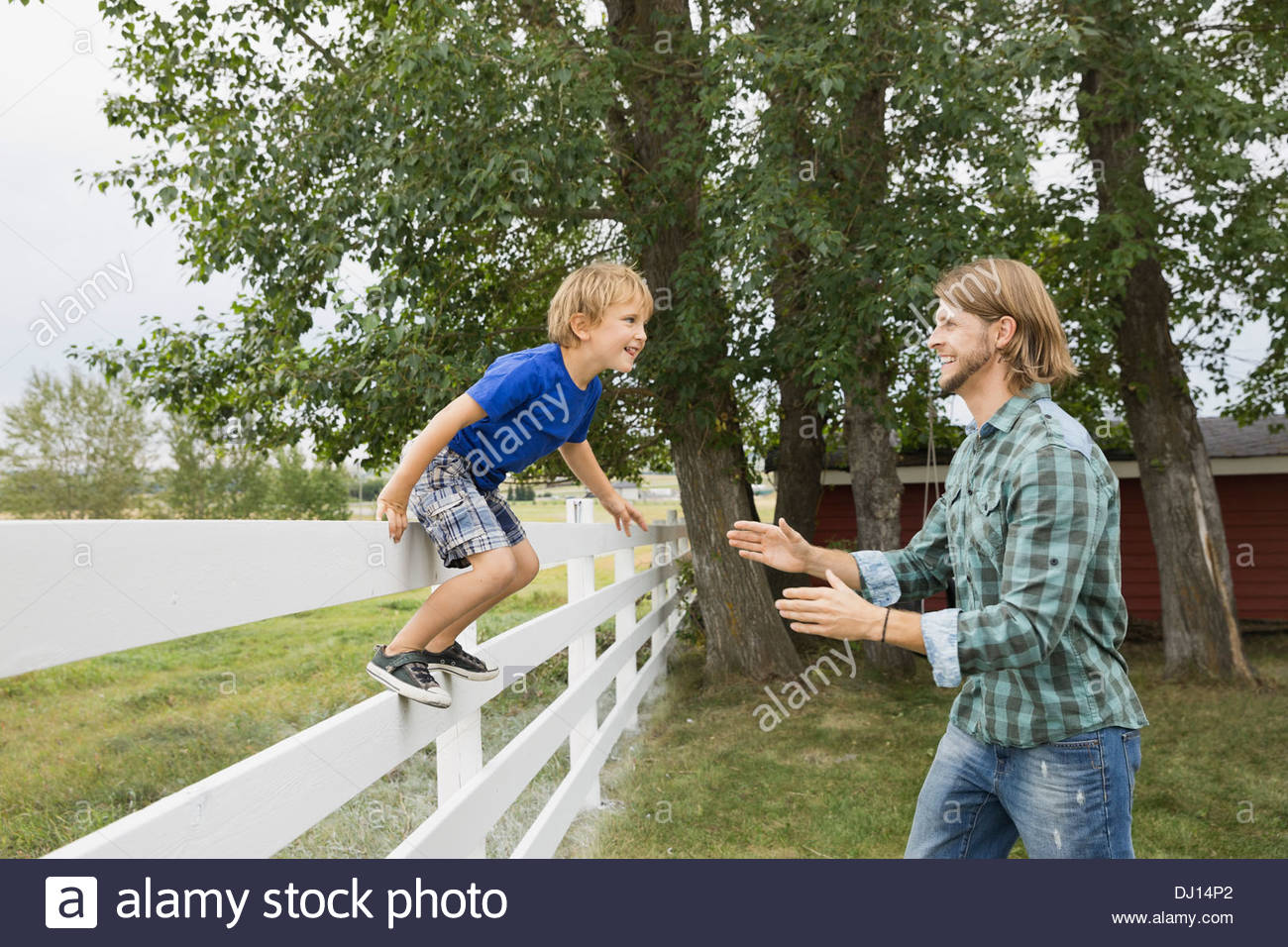 Child jumping fathers arms hi-res stock photography and images - Alamy