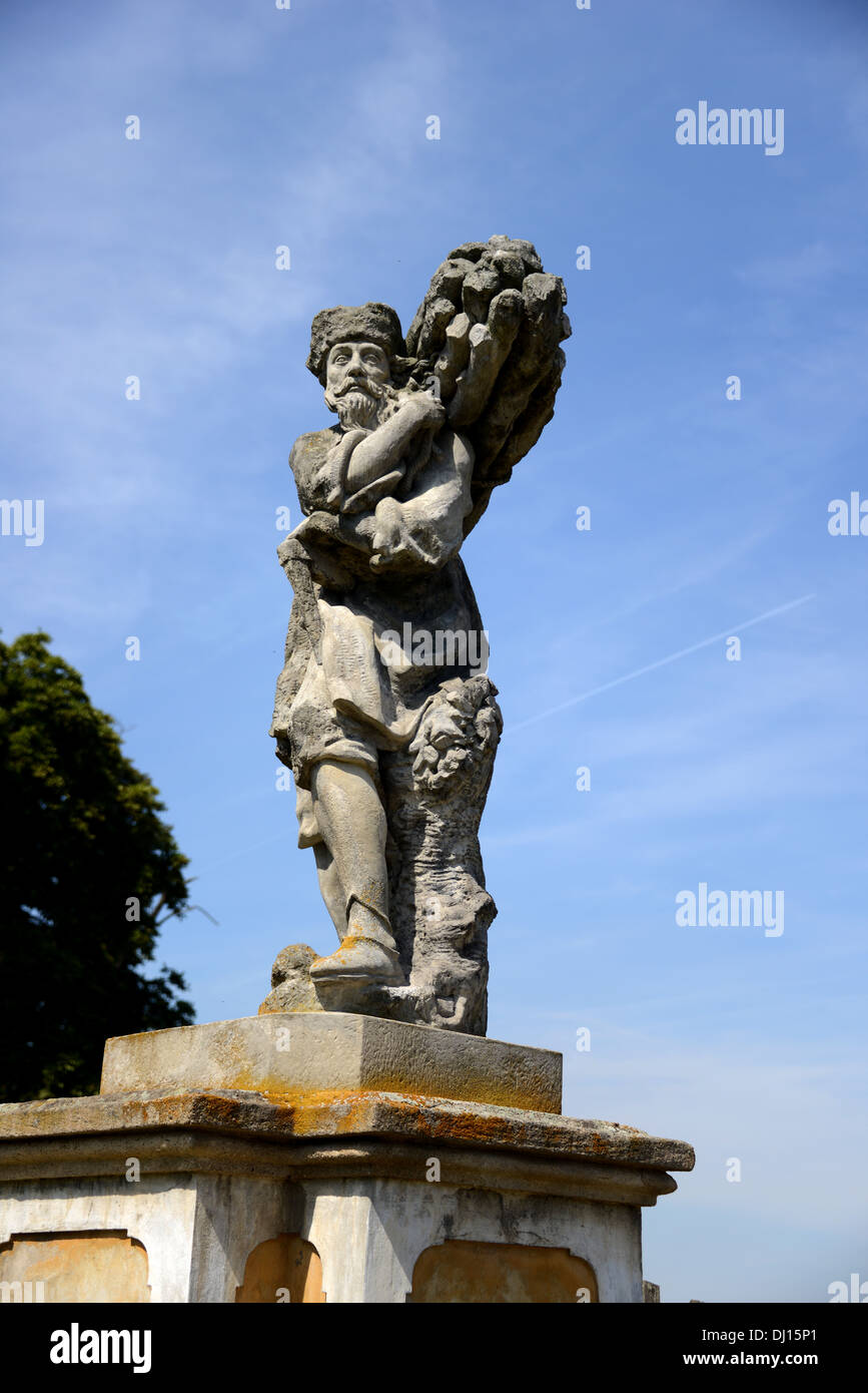 Man with a burden - statue Stock Photo - Alamy