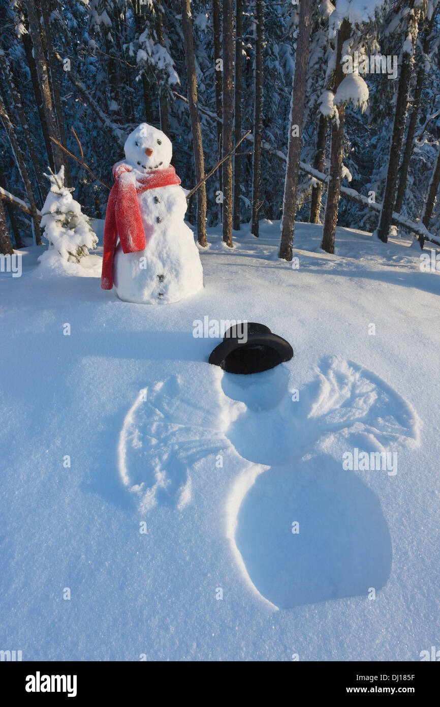 Snowman And Freshly Made Snowman Snow Angel In Front Of A Spruce Forest ...