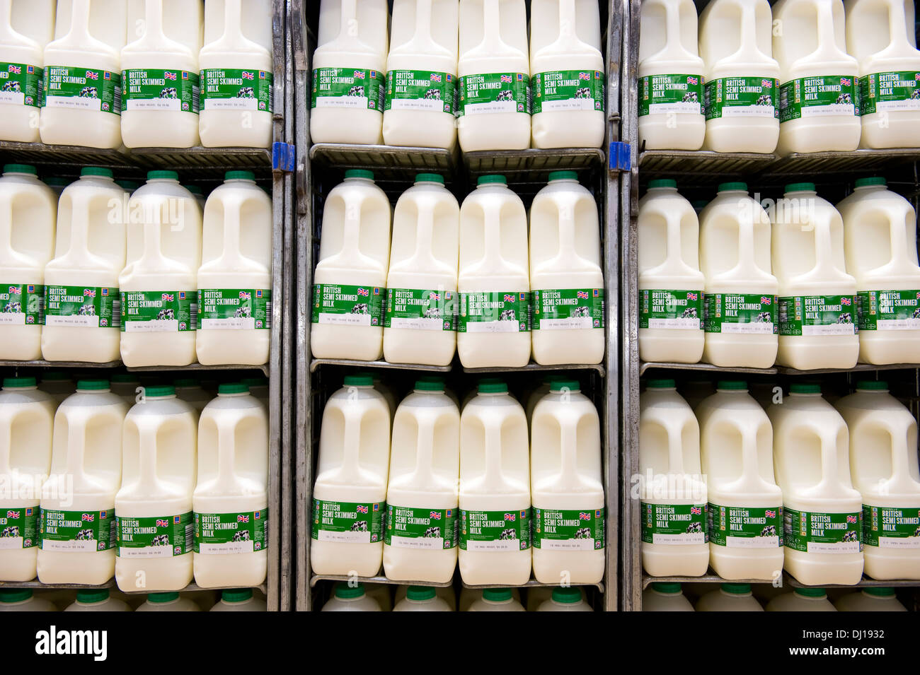 Plastic four pint bottles of British semi skimmed milk stacked in a ...
