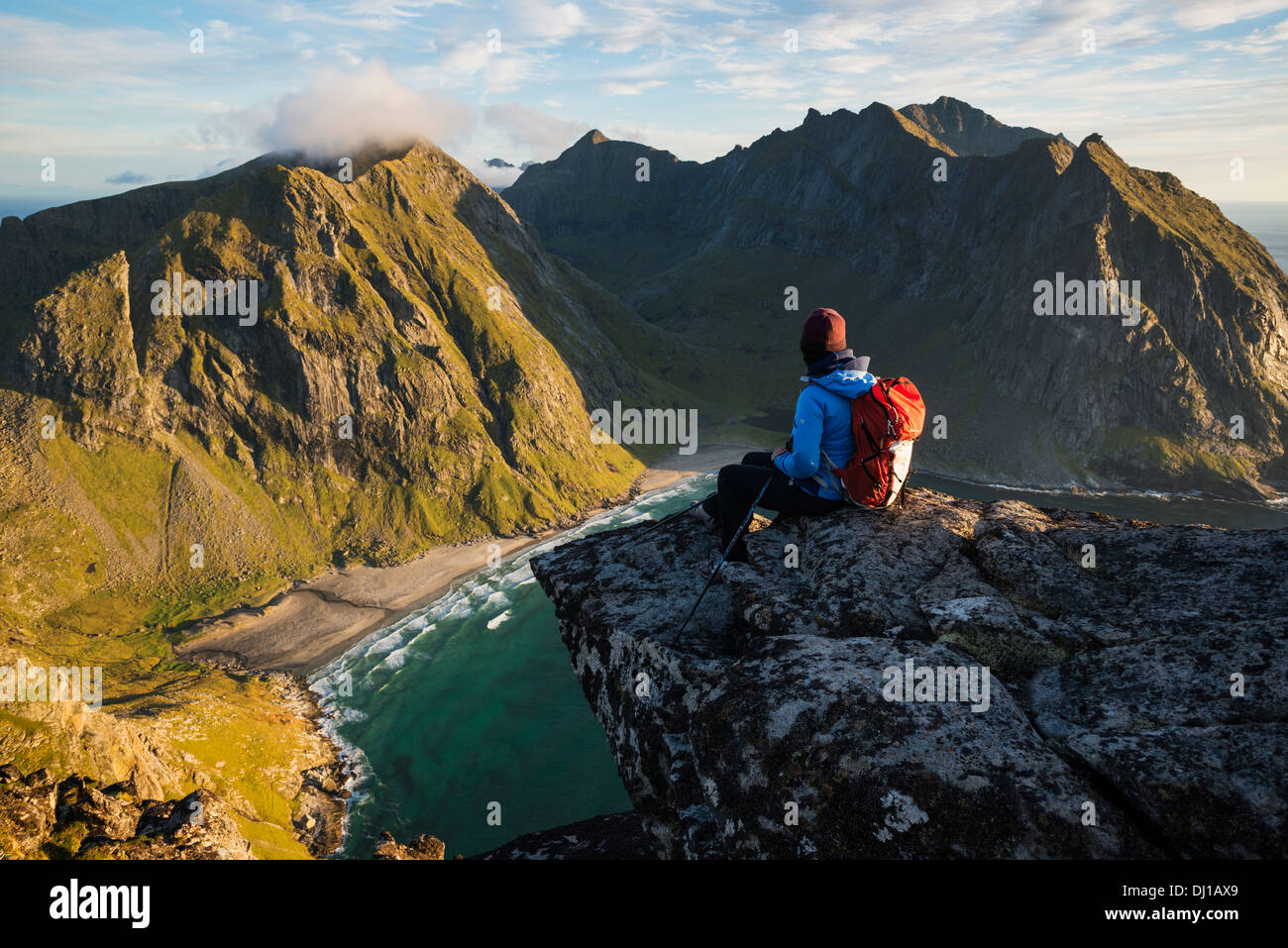 Female hiker enjoying view of Kvalvika beach from near summit of Ryten ...