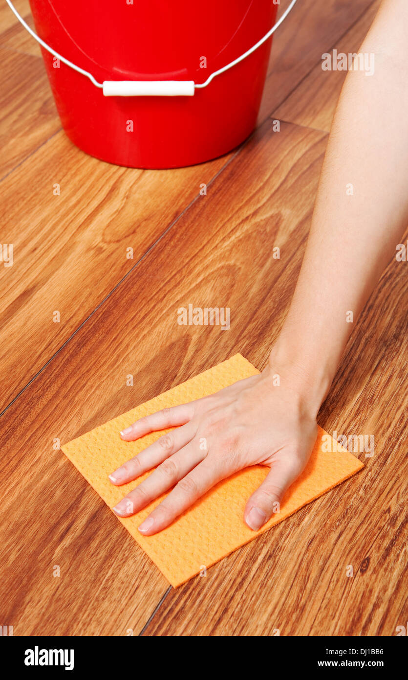 Woman's hand cleaning the floor with yellow sponge Stock Photo - Alamy