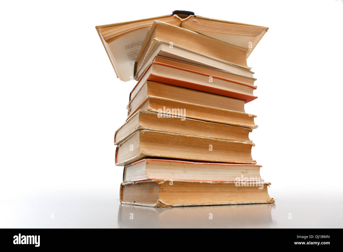 Collection of old books stacked with one opened face-down on top Stock ...