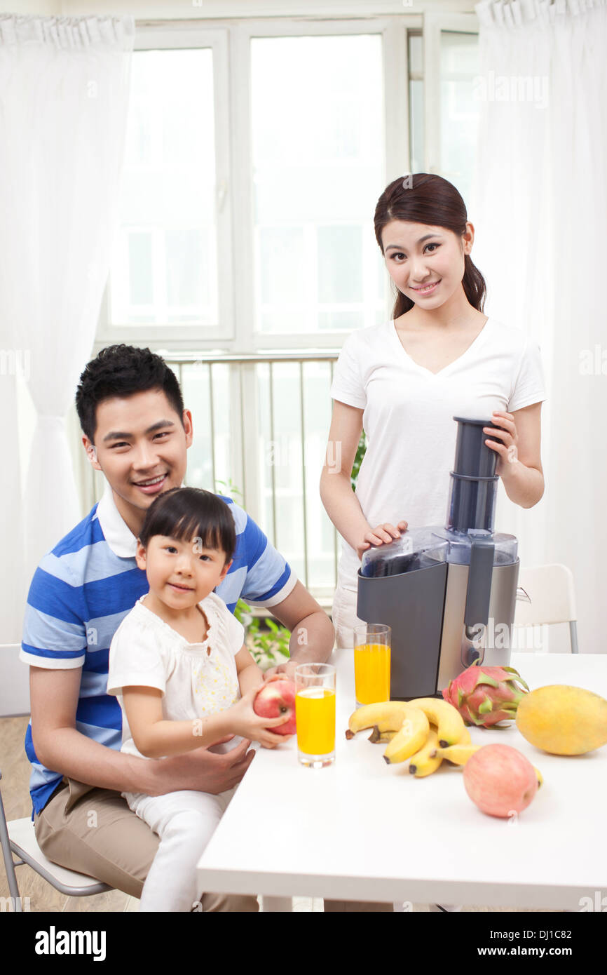 Happy family making juice with electric juicer Stock Photo - Alamy