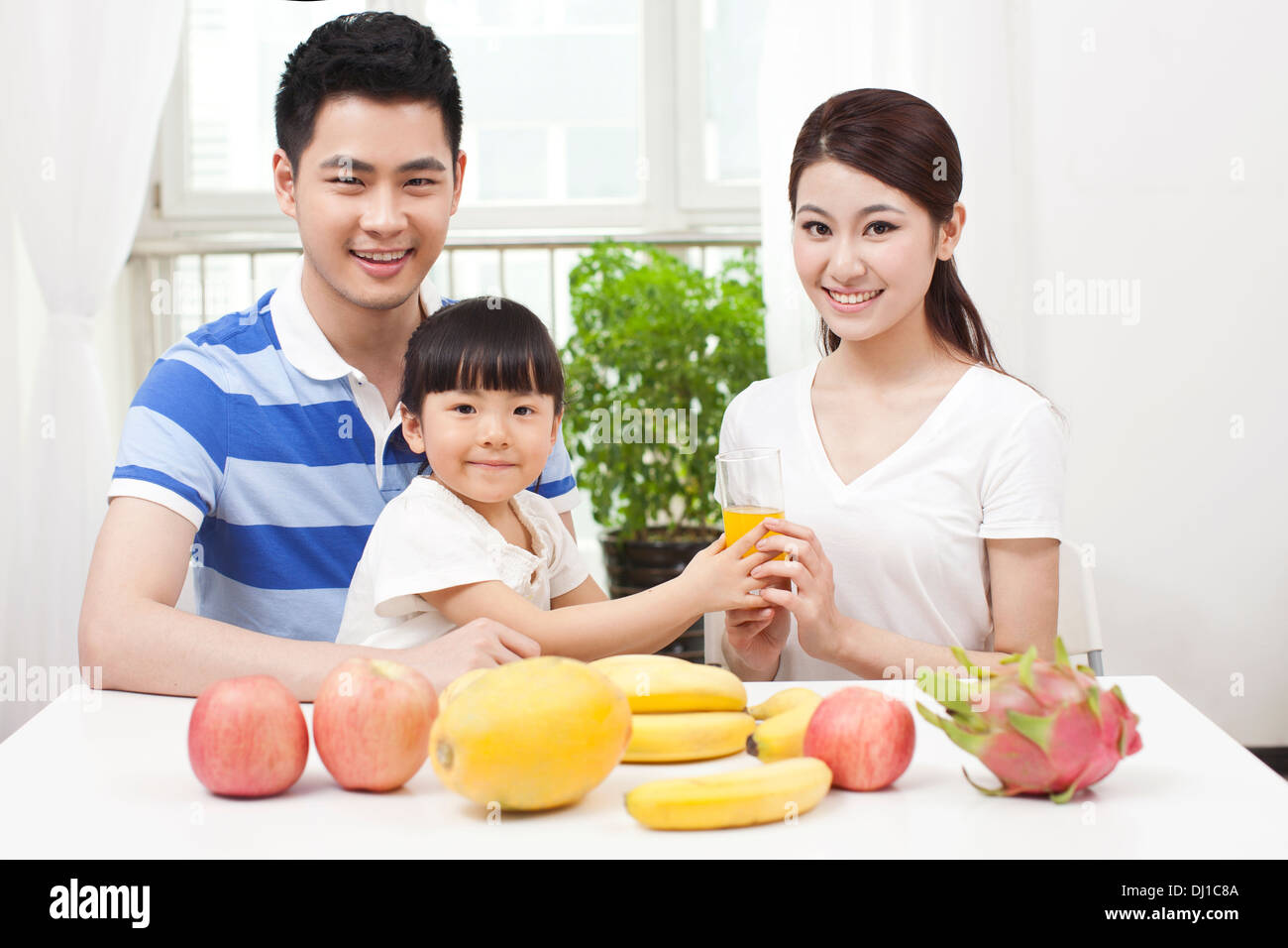Happy family making juice with electric juicer Stock Photo - Alamy