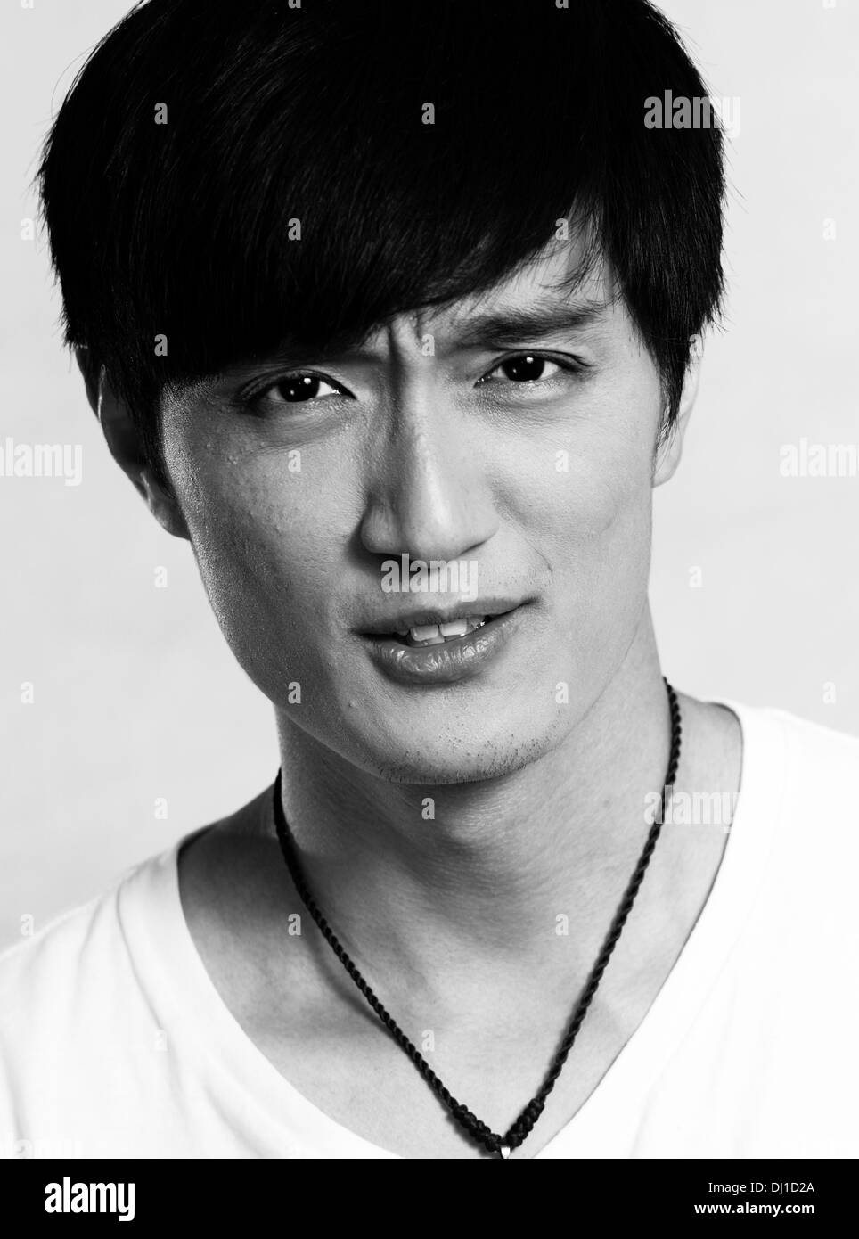 Portrait of young man looking annoyed, black and white style and gray ...