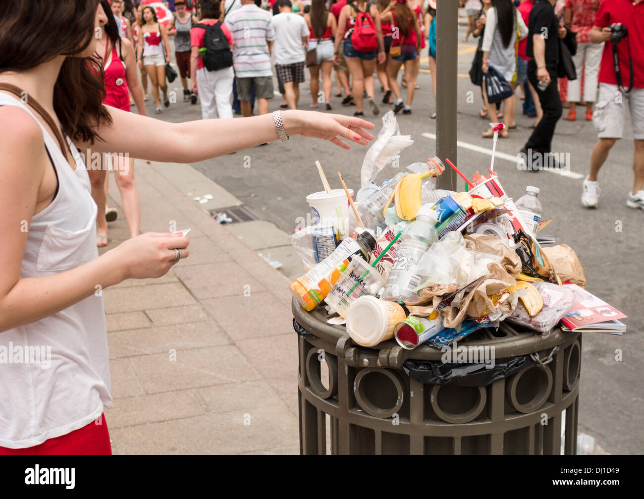 Full -- Overflowing Trash. A street side trash bin overflows with waste ...
