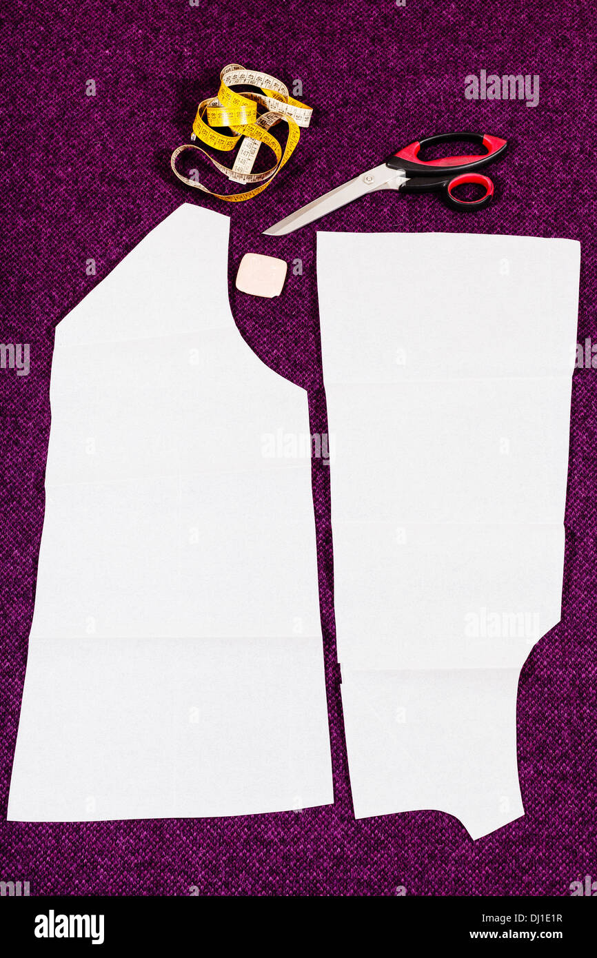 tailor tools and pattern cut of woollen dress on cutting table Stock ...