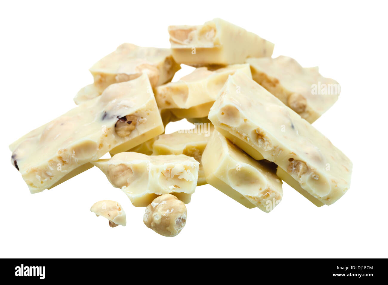 pile of broken white chocolate with hazelnuts isolated on white ...