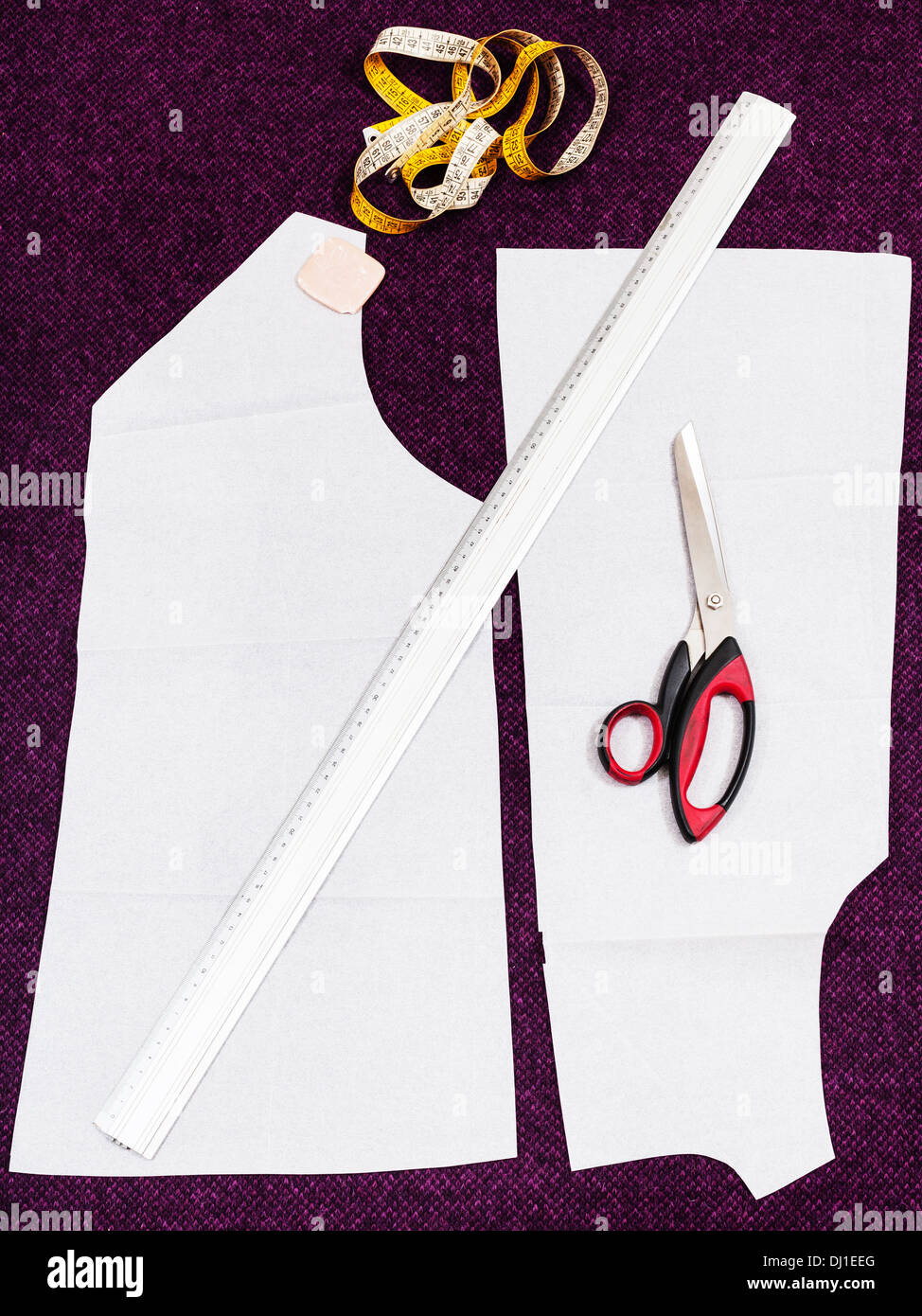 tailor instruments and pattern cut of woollen dress on cutting table ...