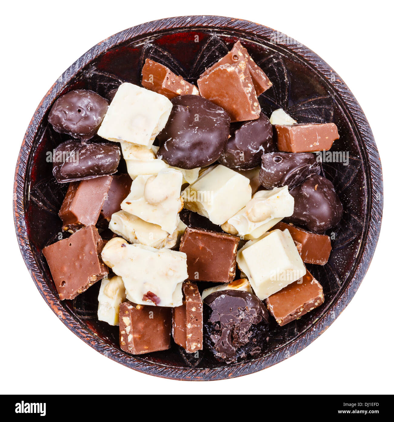 chocolate candies and broken bars in ceramic bowl isolated on white ...