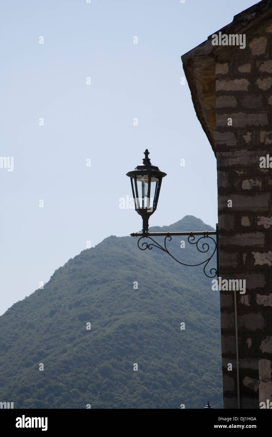 Old fashioned decorative street lamp on corner wall of building ...