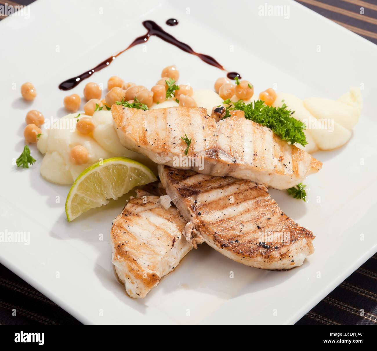 Grilled butterfish w potato puree peas and lemon Stock Photo - Alamy